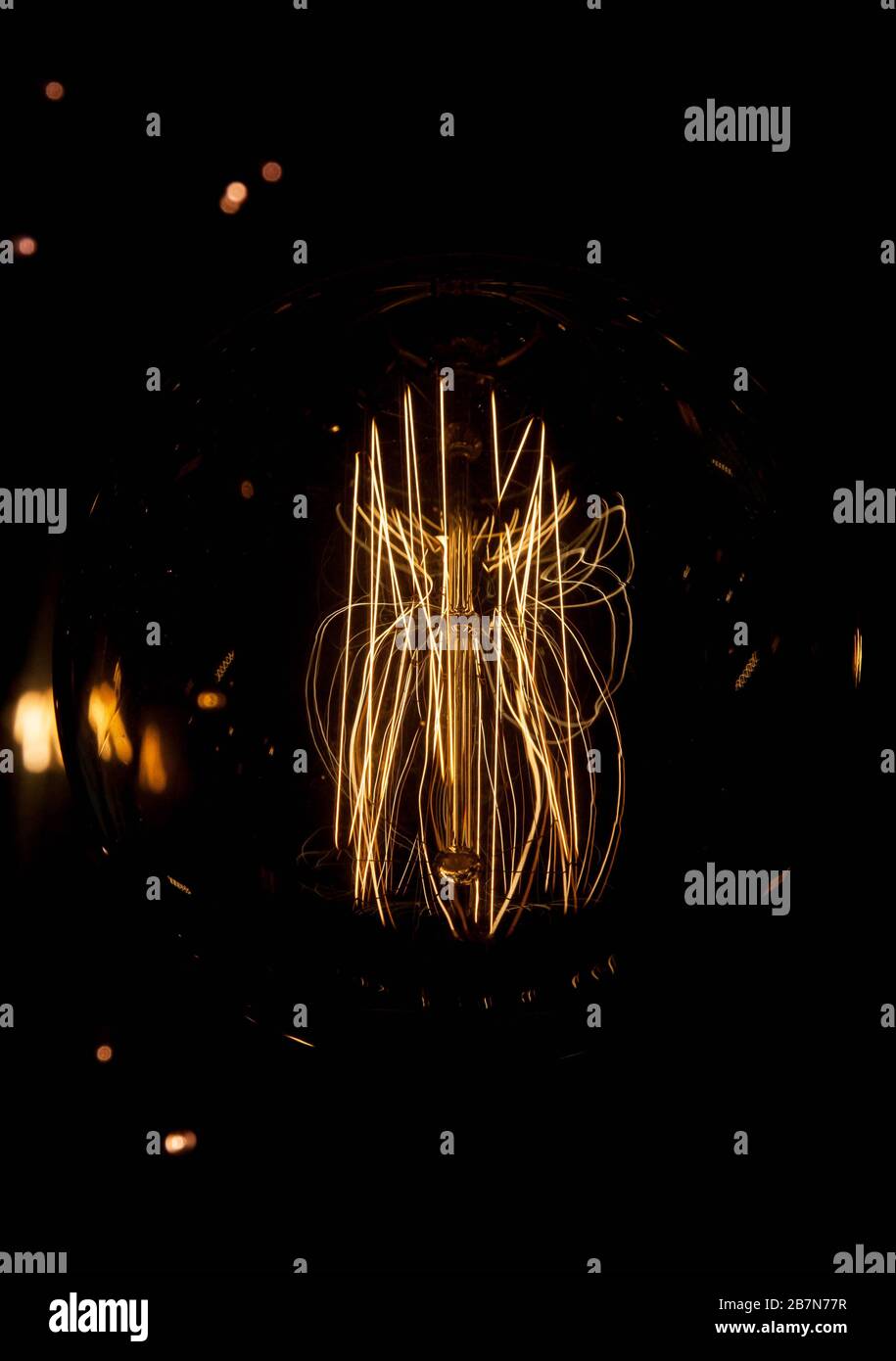 Luminous thread of a retro Edison lamp on a dark background Stock Photo ...