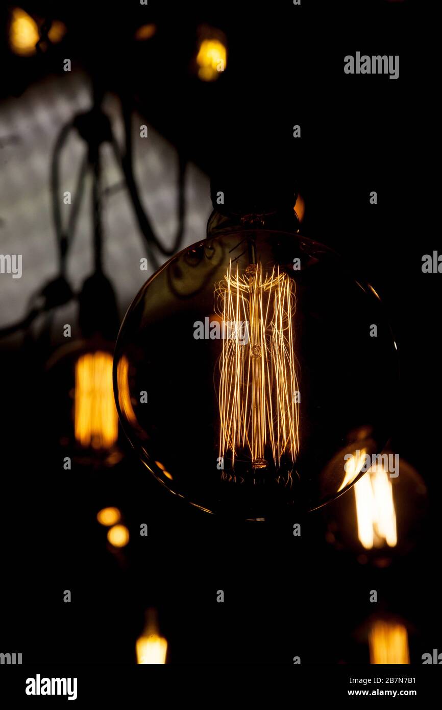 Luminous thread of a retro Edison lamp on a dark background Stock Photo ...