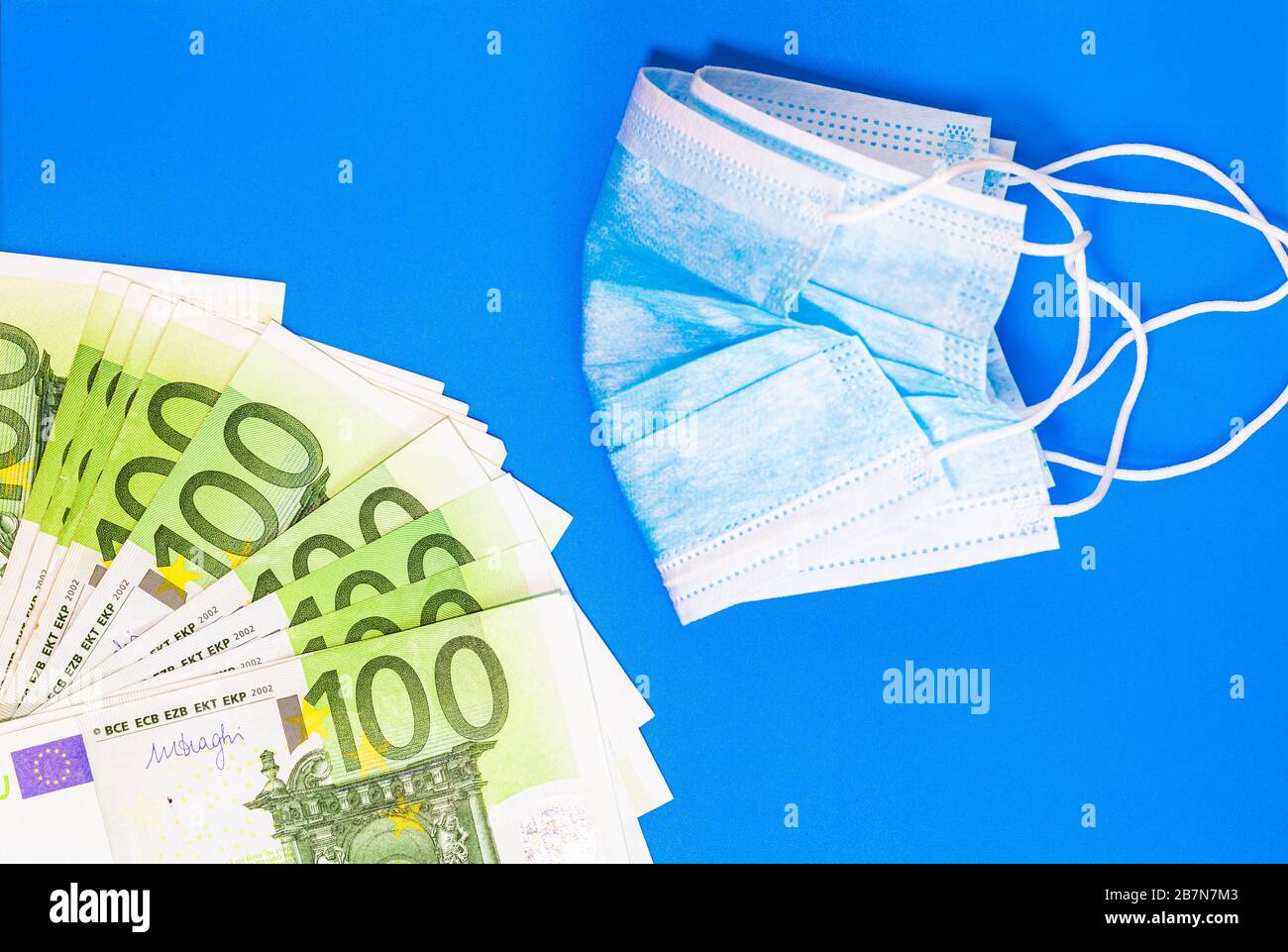 Money with surgical mask on wooden table. Flu disease virus spreading ...