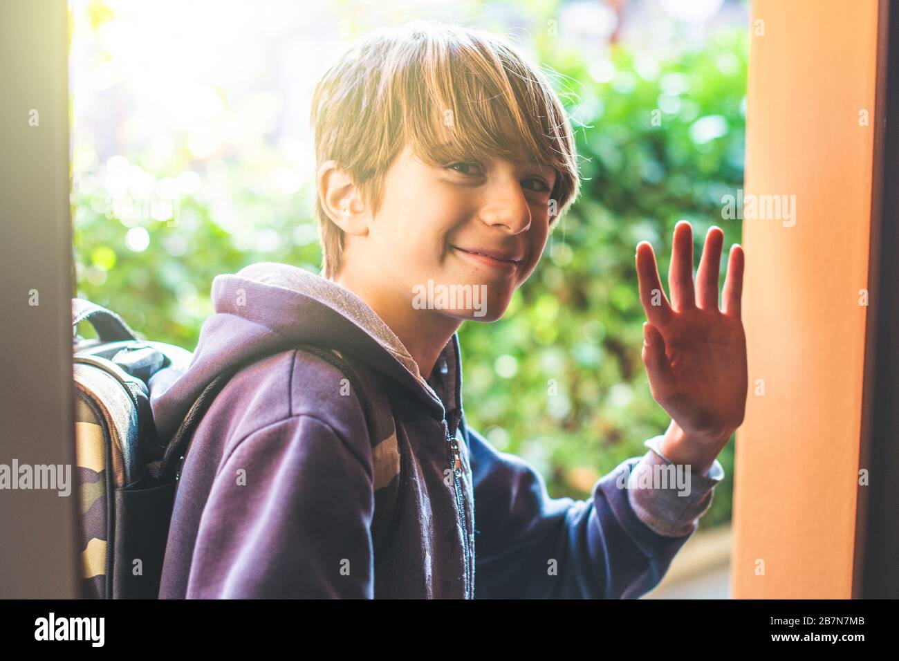Young boy greets as he leaves home to go to school New day of ordinary ...