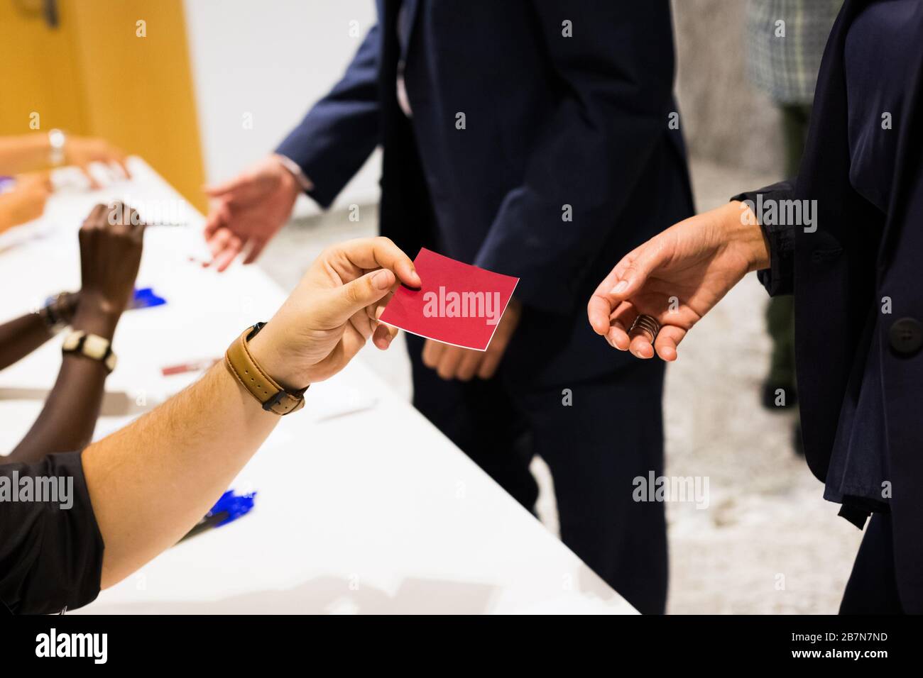 Woman hands out a blank red card in hand during a promotional ...