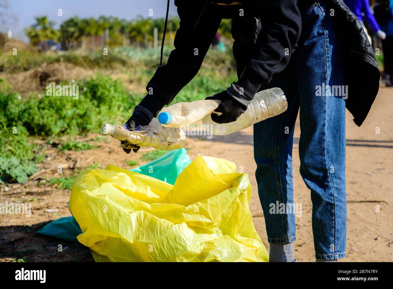 People cleaning the nature of garbage and pollution of plastic bottles ...