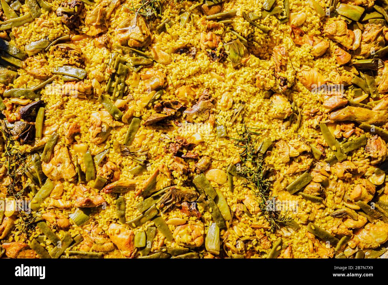 Yellow rice with meat and vegetables, Valencian paella, typical dish of ...