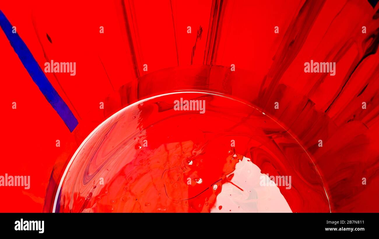 Abstract background of spilled red paint with buckets on a black ...