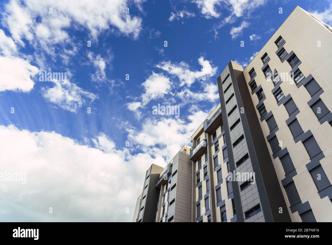 Block of tall residential buildings with clouds in the background at ...