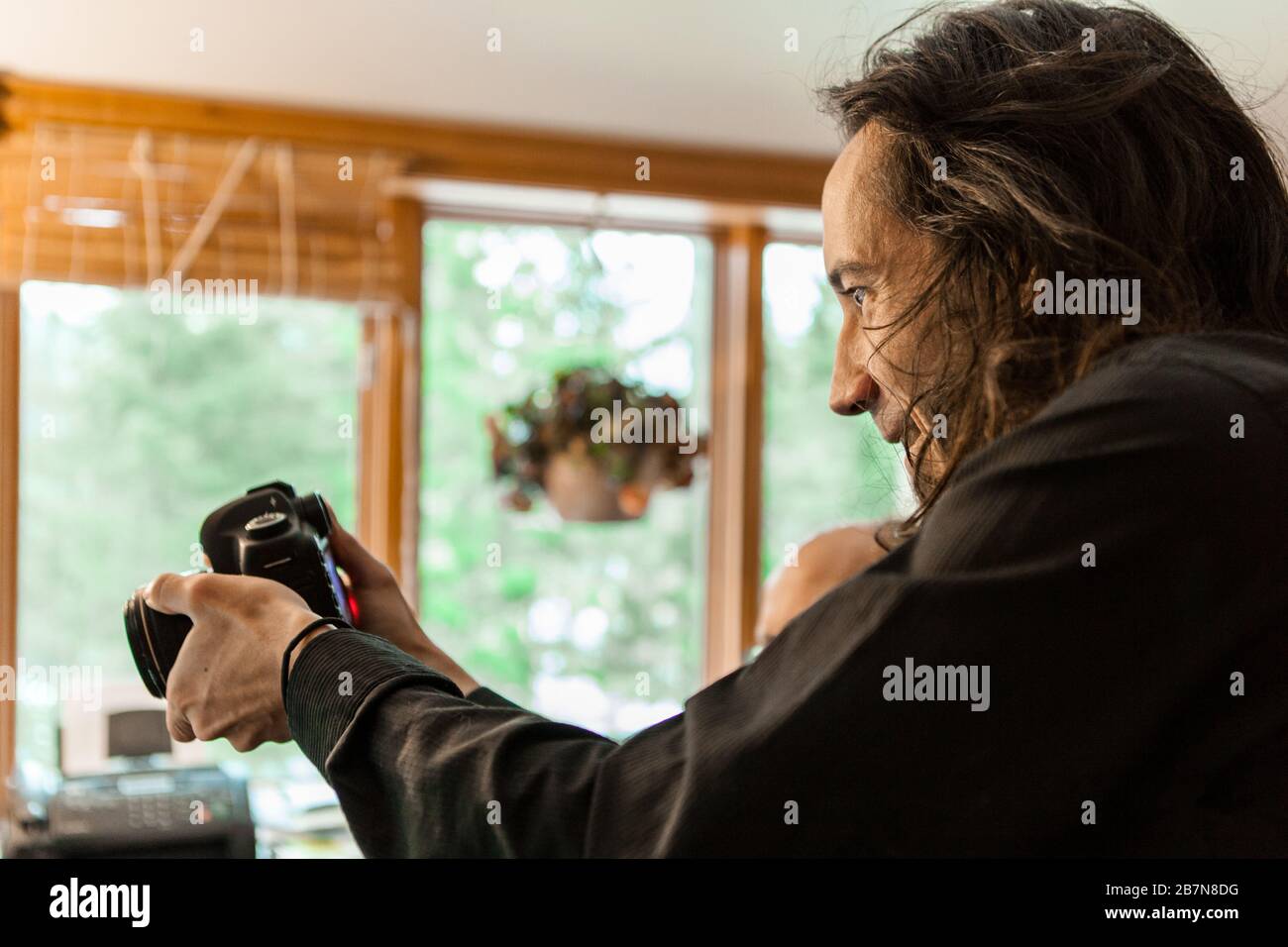 A close up and side profile of a professional male photographer ...