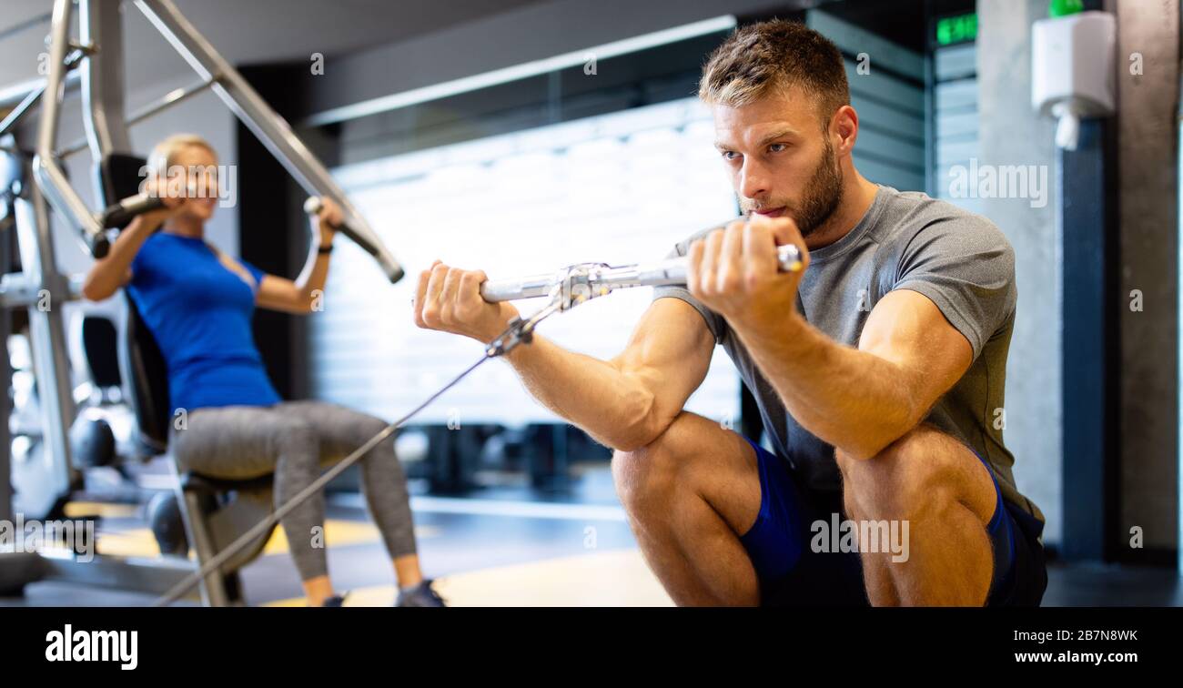 Man with weight training equipment exercising in sport gym club Stock ...