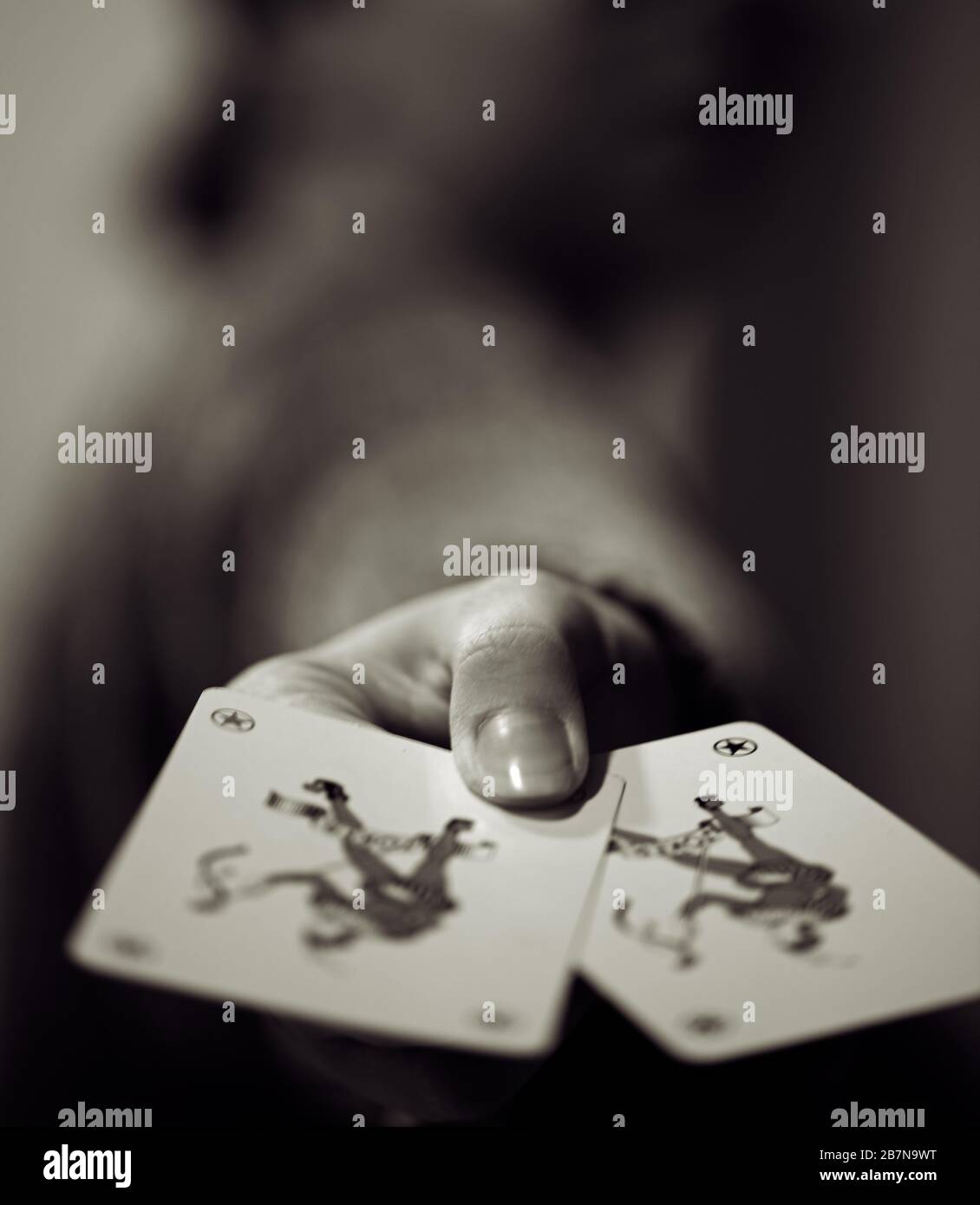 Girl holding joker playing cards Stock Photo - Alamy