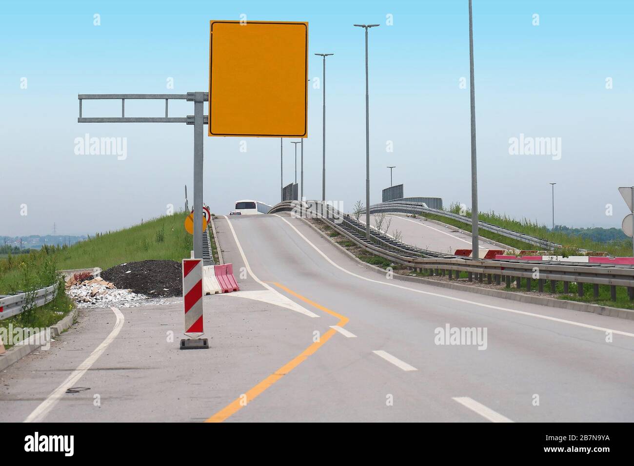 Empty highway driveway with traffic board and landscapes on sides Stock ...