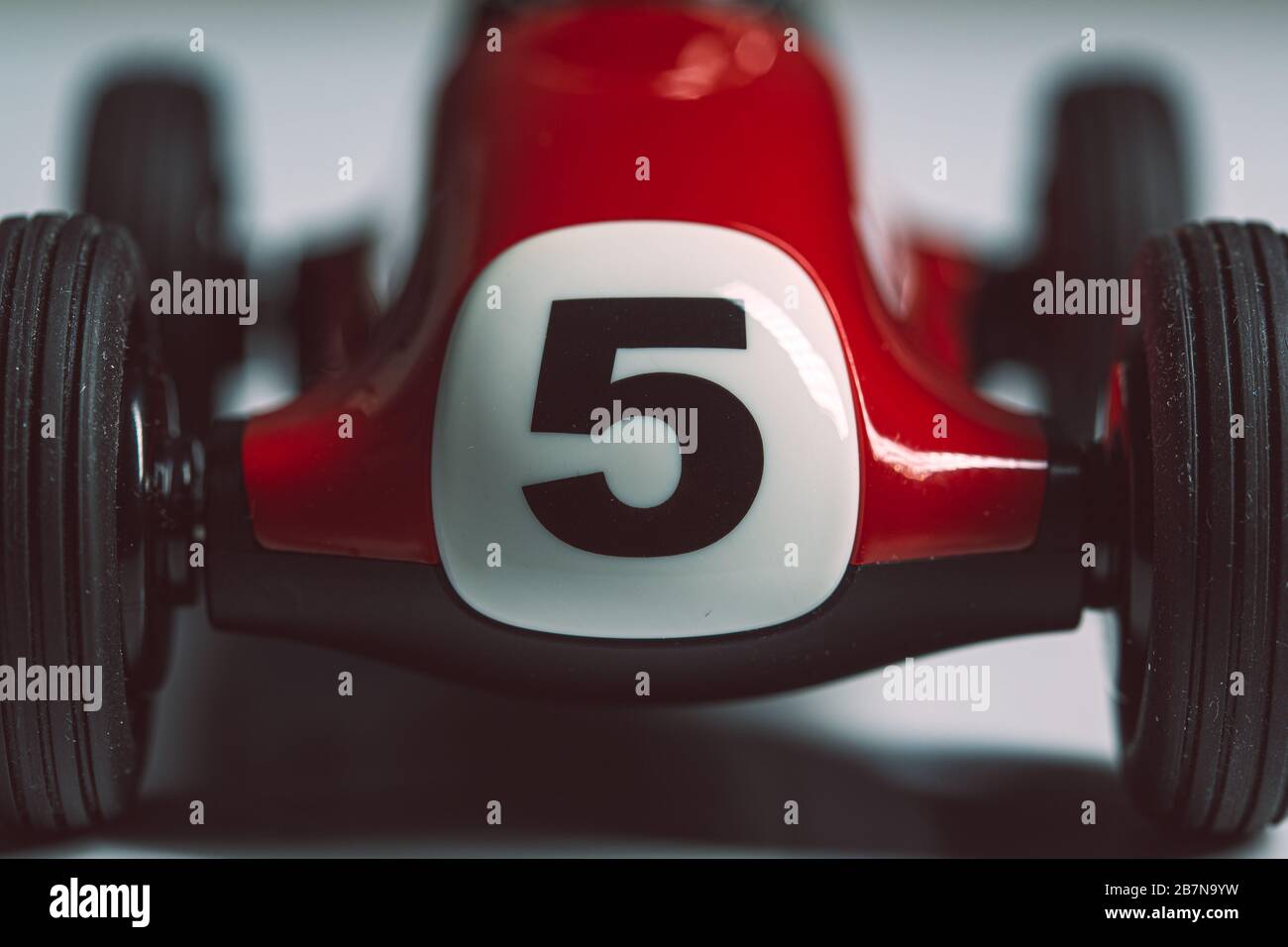 Number five painted on a white car plate on a red toy vintage racing ...