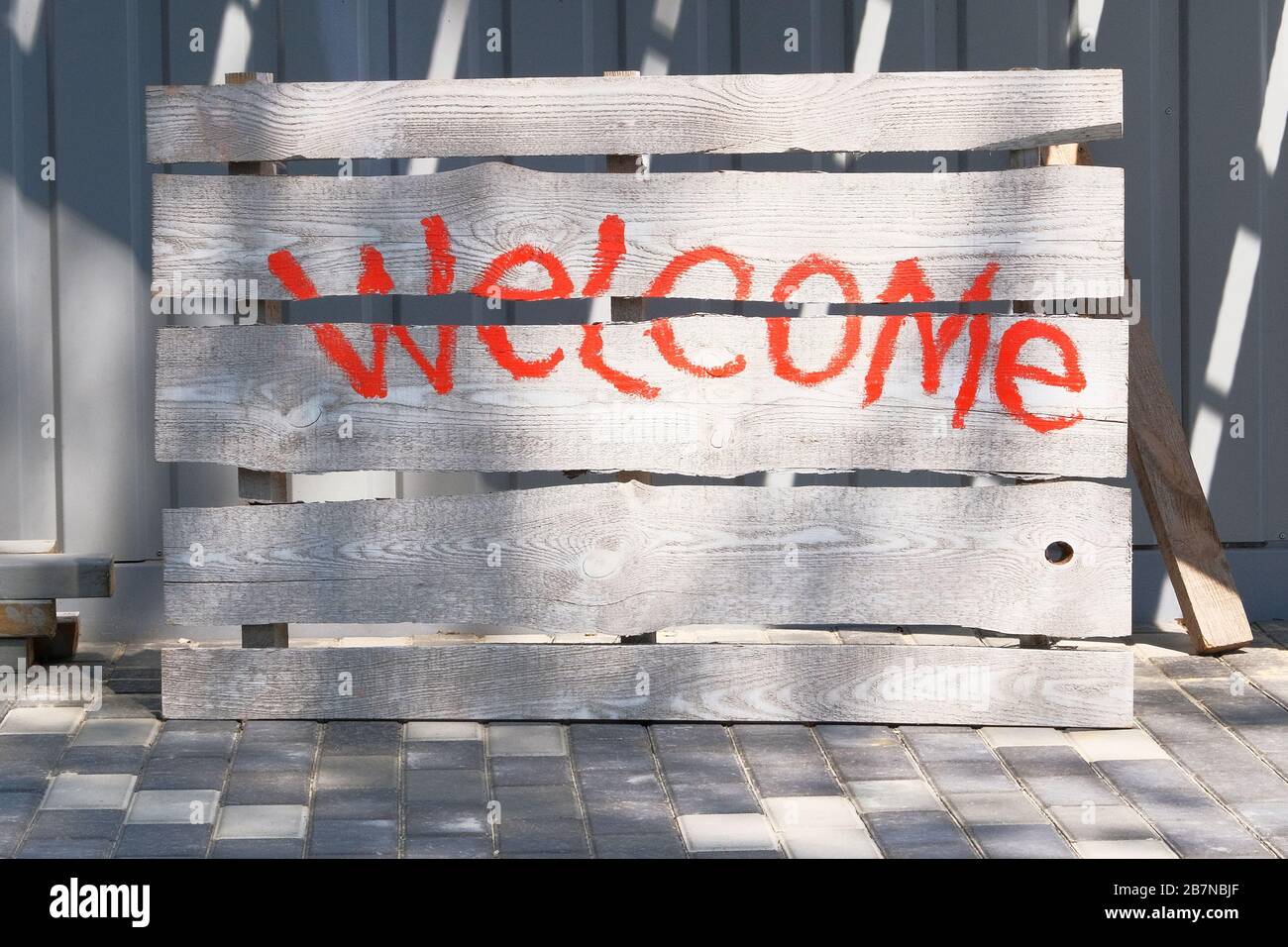 Inscription on gray wooden board - Welcome. Plank surface texture ...