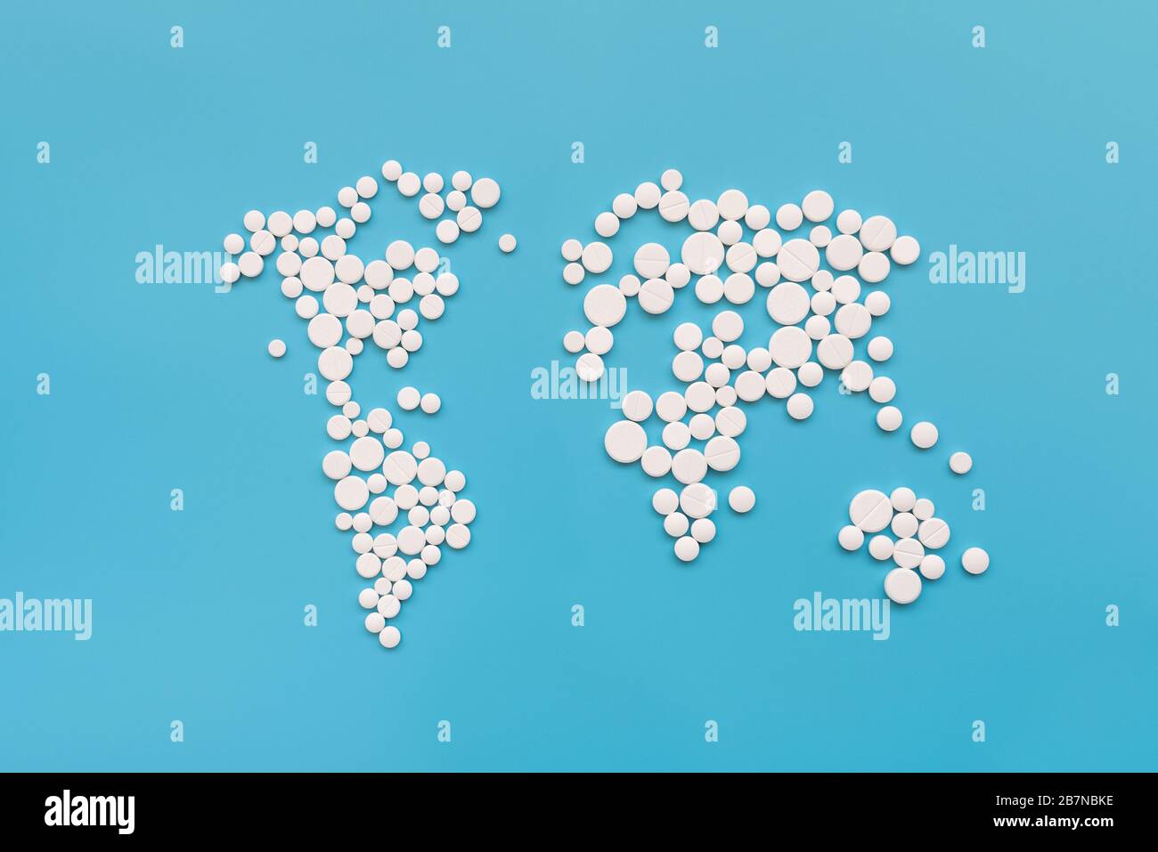 Covid-19. World map shape make from white pills on blue background. Flu ...