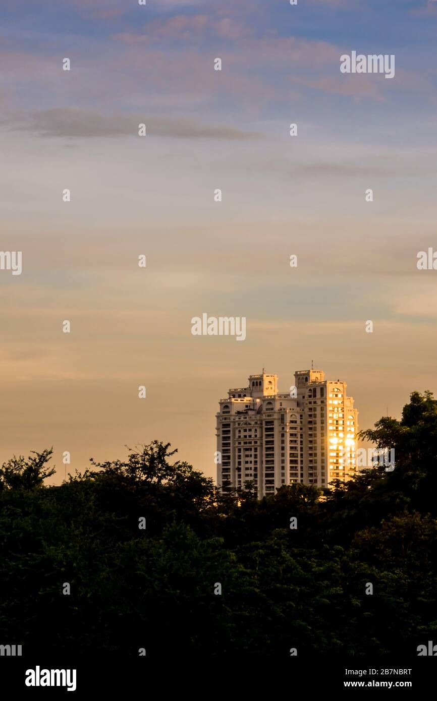 Light of the morning sun reflected on the glass of the high-rise ...