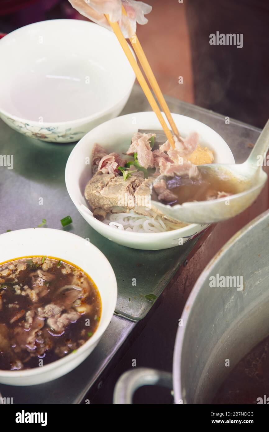 Vietnam, Hue. Food and Drink. Bun Bo - spicy beef and noodle soup in a ...