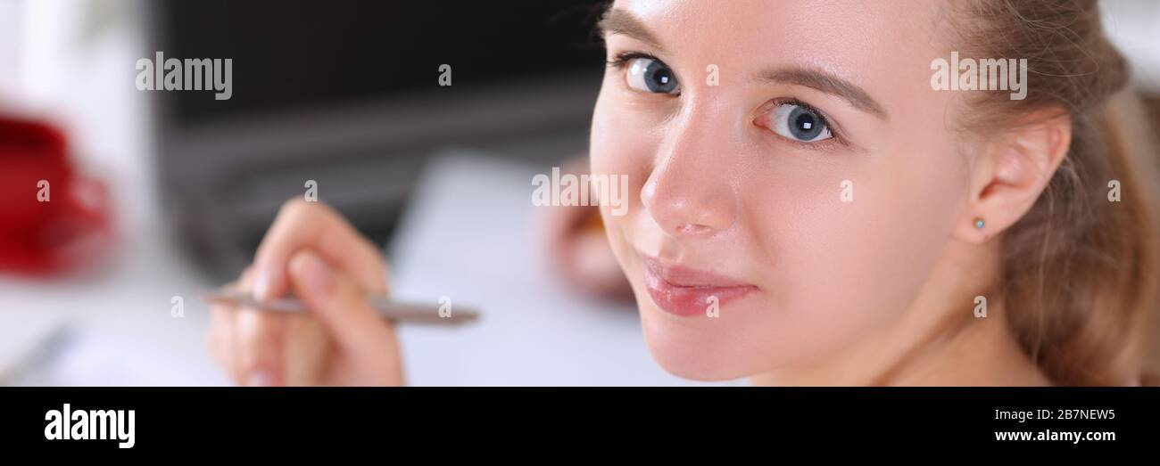 Cute woman writing report Stock Photo - Alamy
