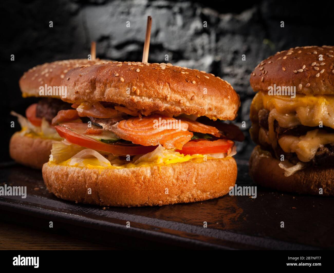 Menu of different burgers on one board. Side view of a fish burger ...