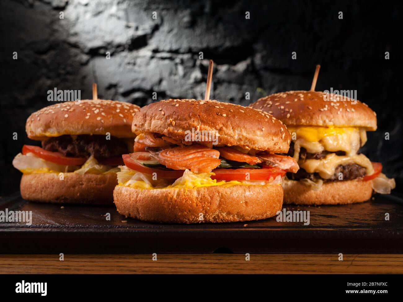 Menu of different burgers on one board. Side view of a fish burger ...