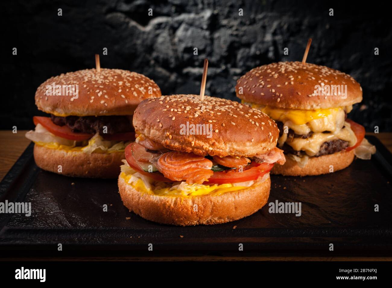 Menu of different burgers on one board. Side view of a fish burger ...