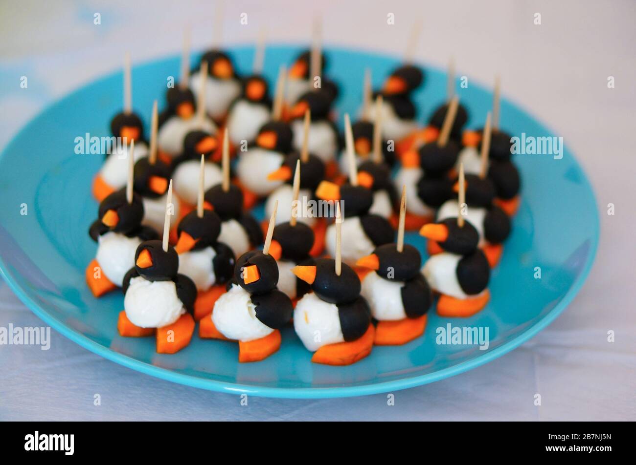 Lot of penguin snacks made with mozzarella cheese and carrots for a ...