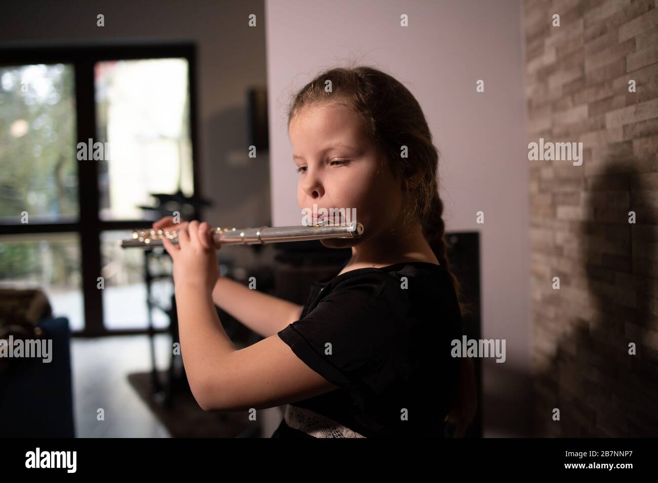 little girl playing the flute at home Stock Photo - Alamy