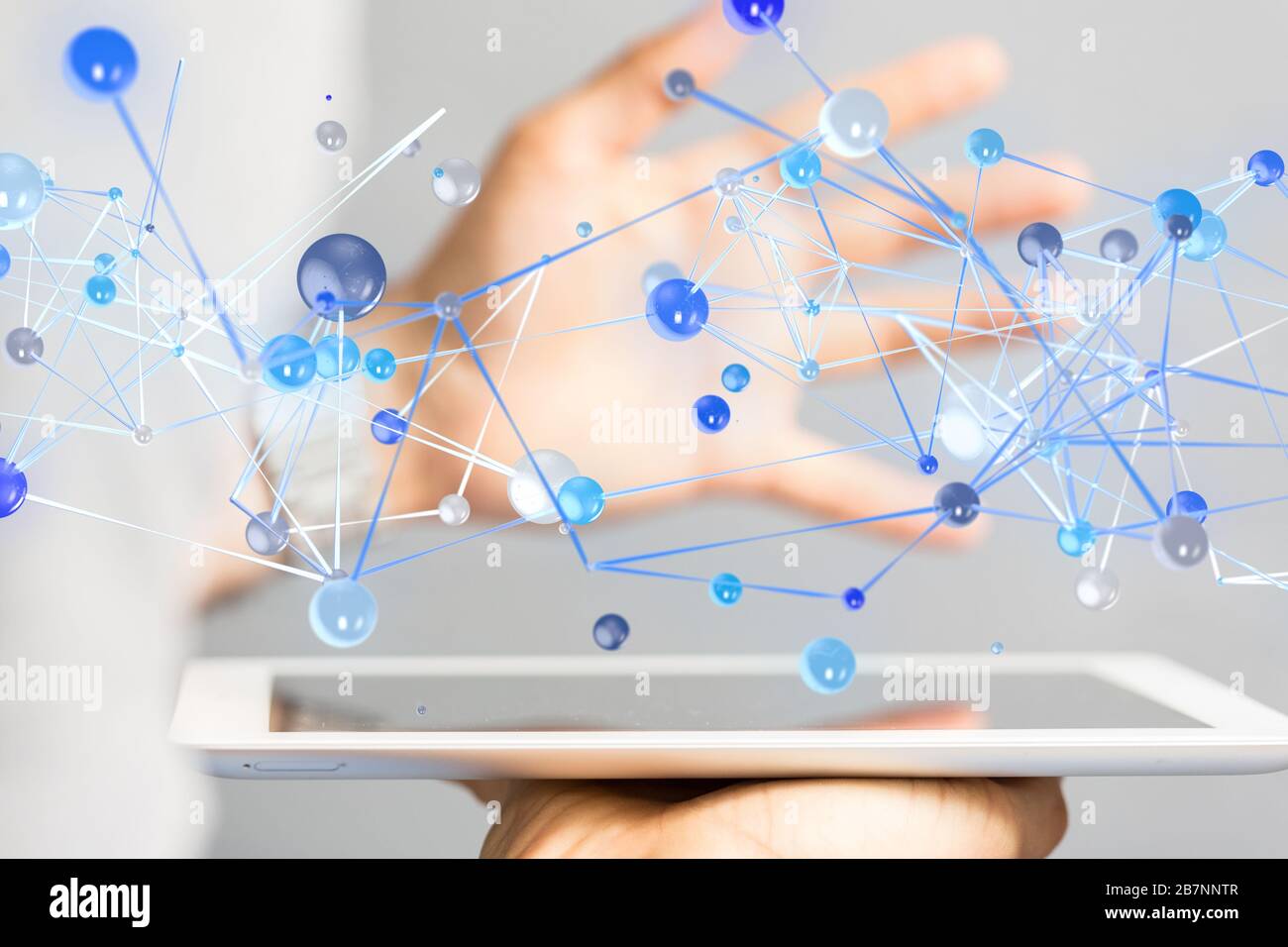Male hand holding an interface with small circles connected depicting ...