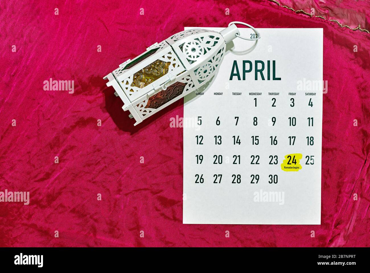 April monthly calendar on the red silk textile background. Islamic ...