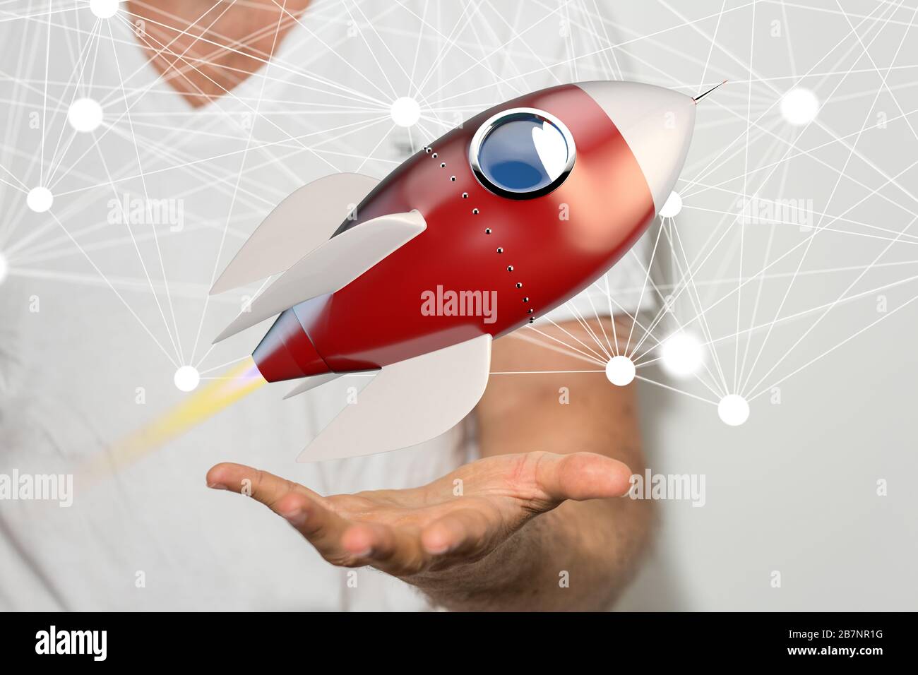 Man wearing a shirt holding a big red rocket icon Stock Photo - Alamy