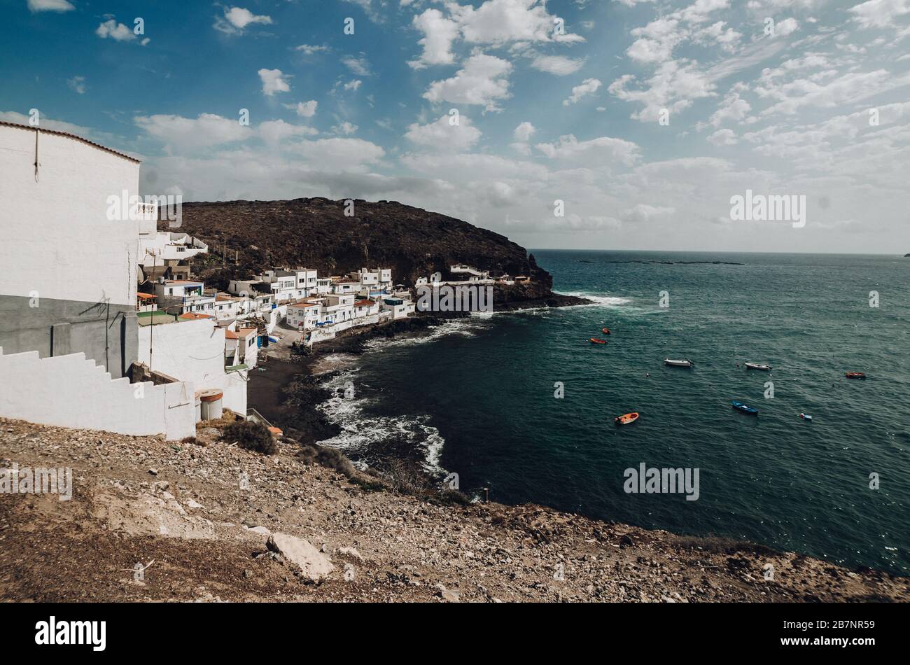 Beautiful village in Canary island with white houses with boats in the ...