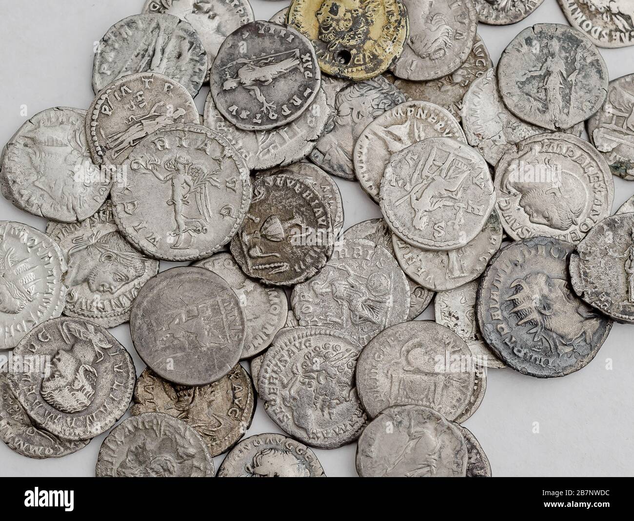 Antique Roman coins, small pile of cash on white background Stock Photo ...