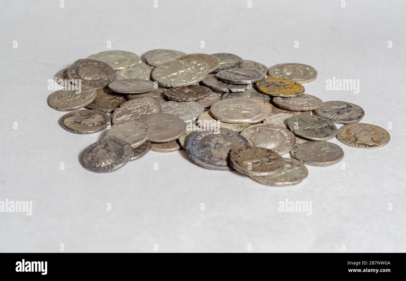 Antique Roman coins, small pile of cash on white background Stock Photo ...