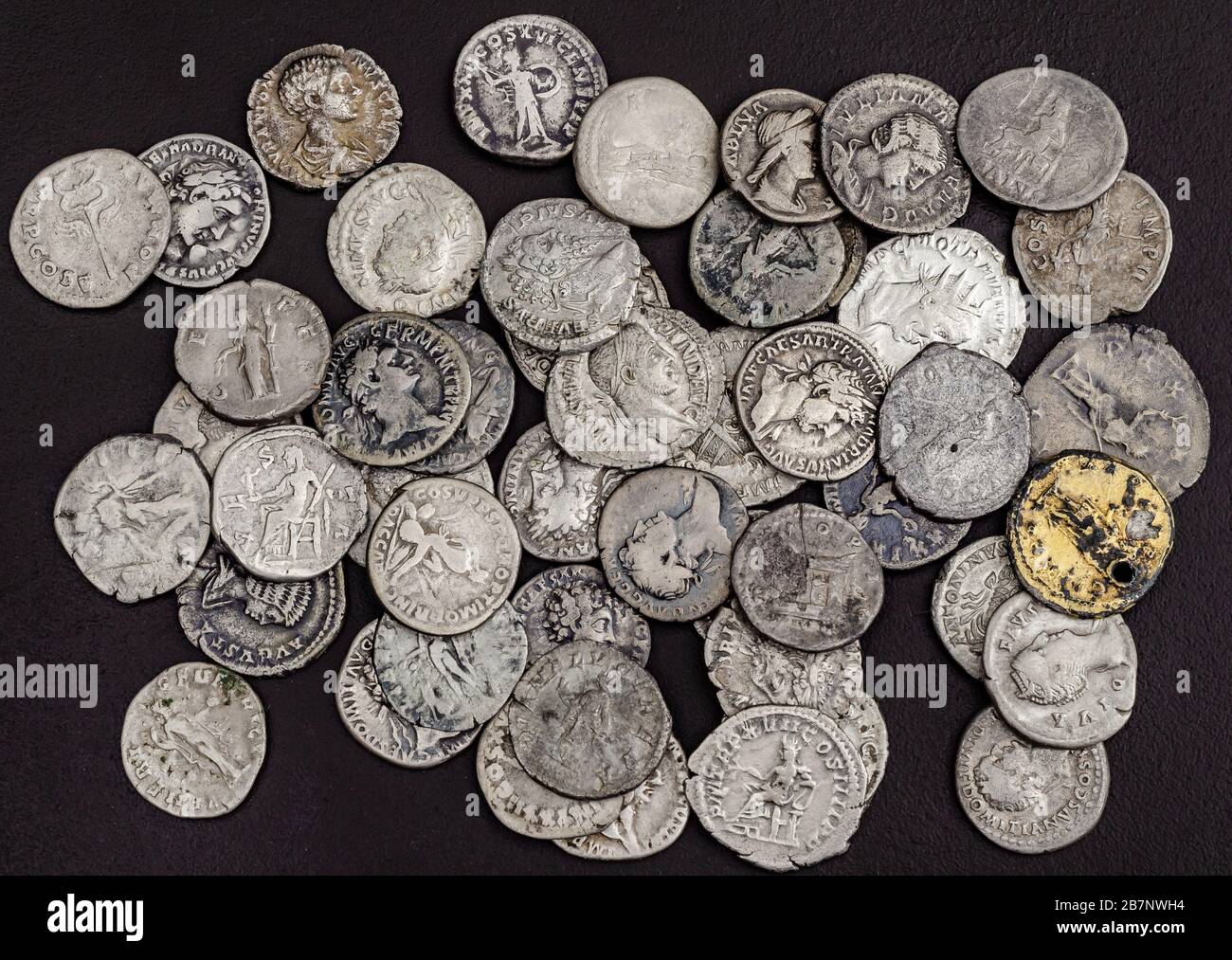Antique Roman coins, small pile of cash on black background Stock Photo ...