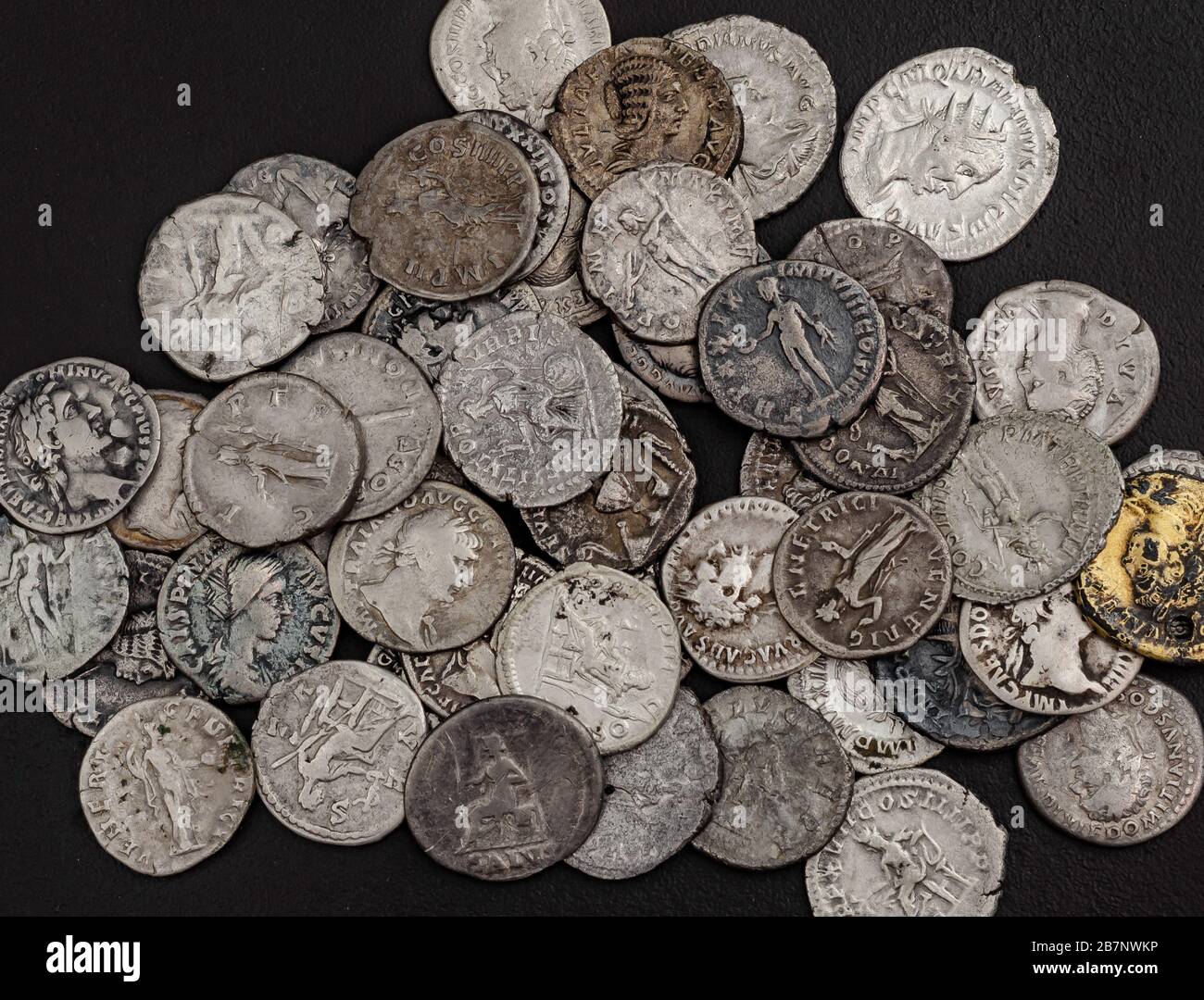 Antique Roman coins, small pile of cash on black background Stock Photo ...