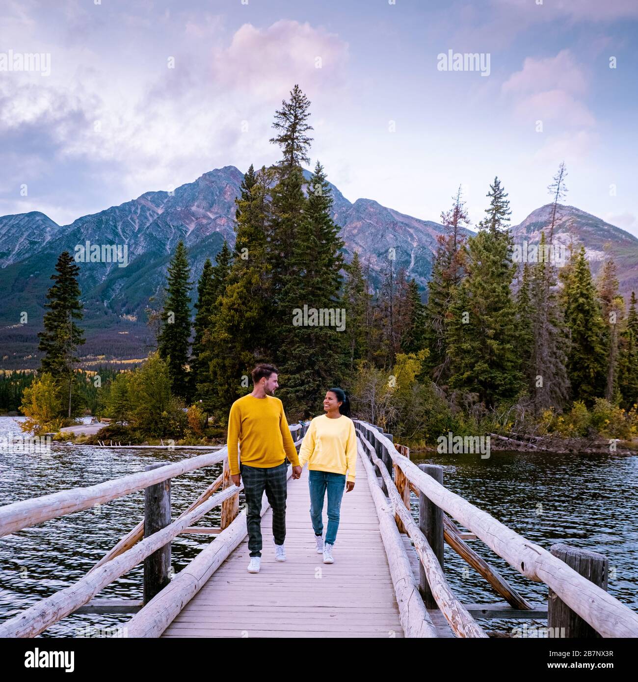 couple by the lake watching sunset, Pyramid lake Jasper during autumn ...