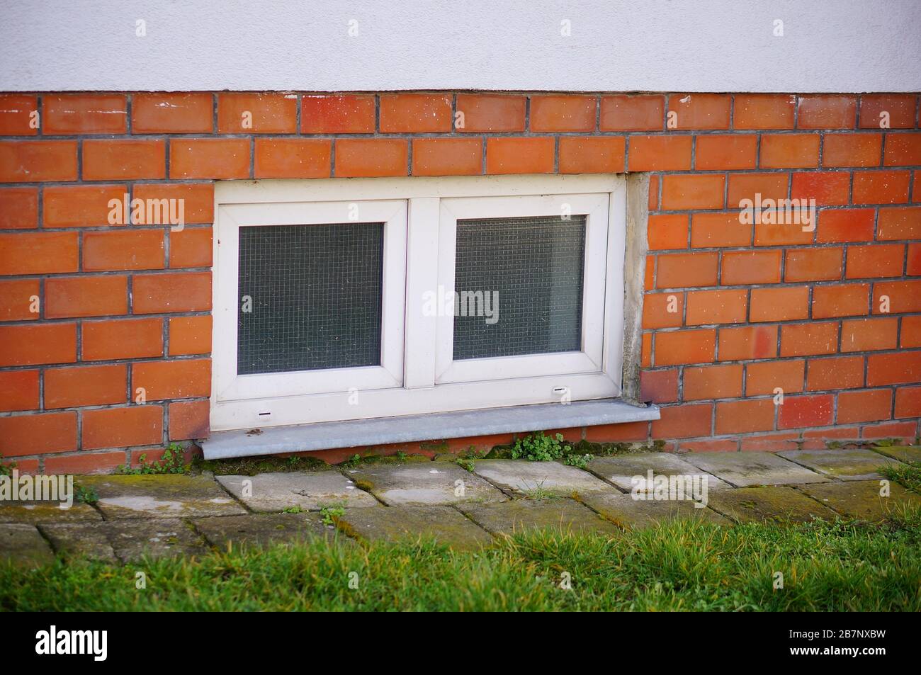 Brick building with a small window Stock Photo - Alamy