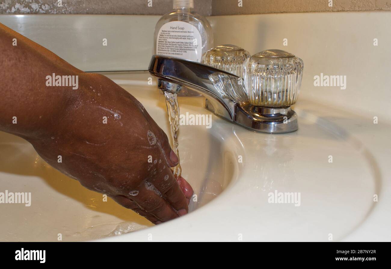 African man washing hands hi-res stock photography and images - Alamy