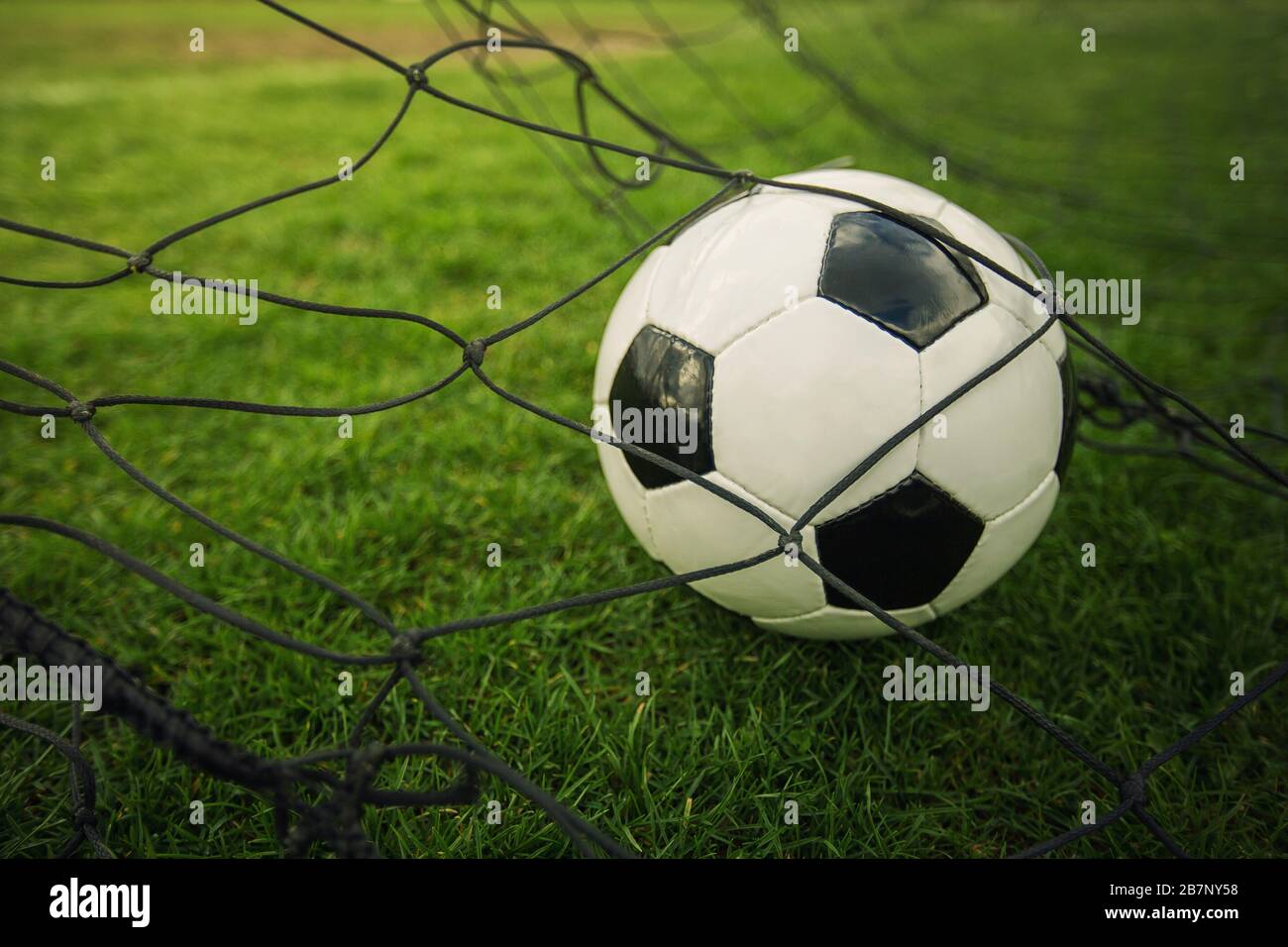 Goal concept as a soccer ball enters the gate and hits the net ...