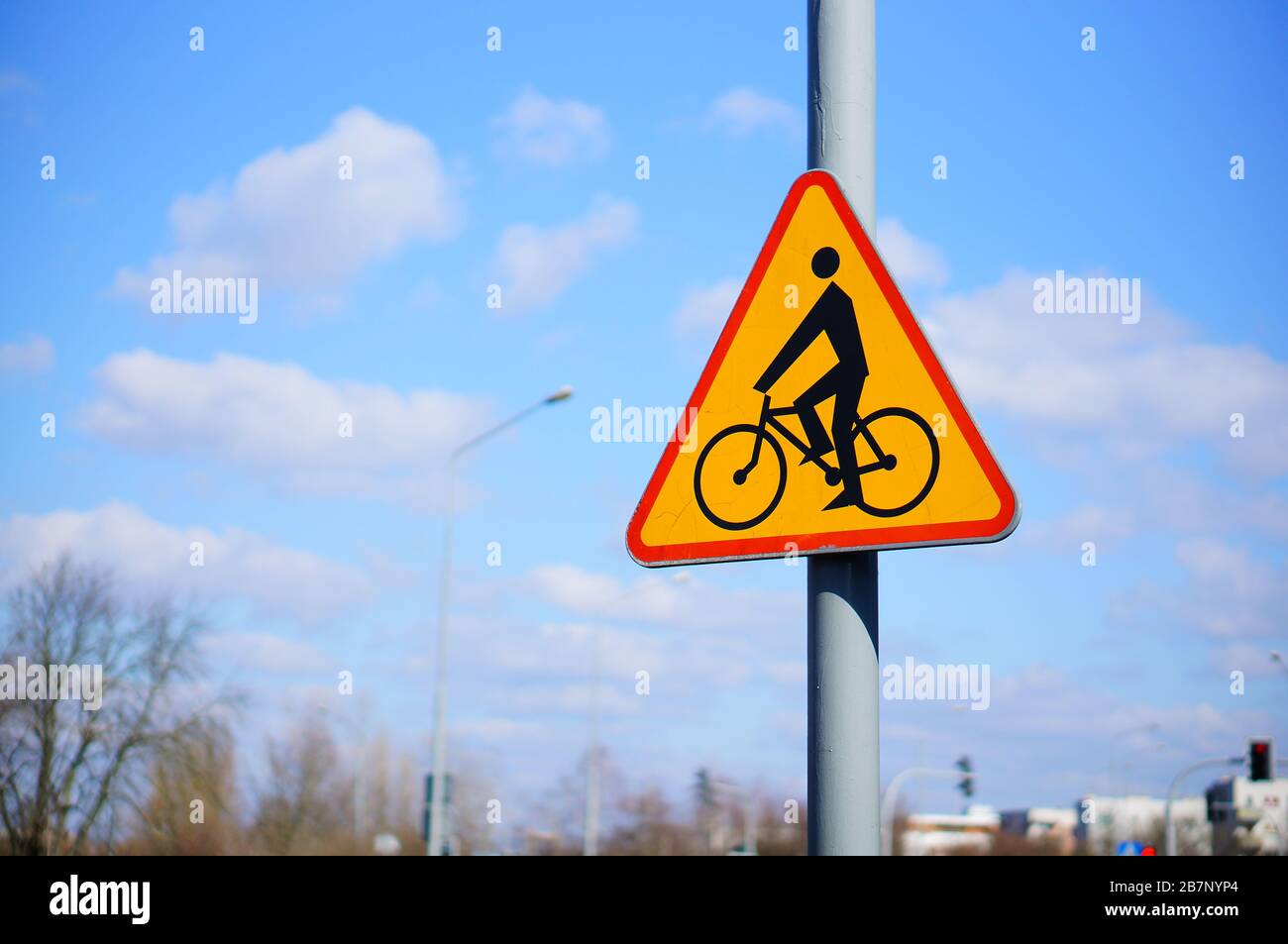 Warning sign on a pole with a blurred background Stock Photo - Alamy
