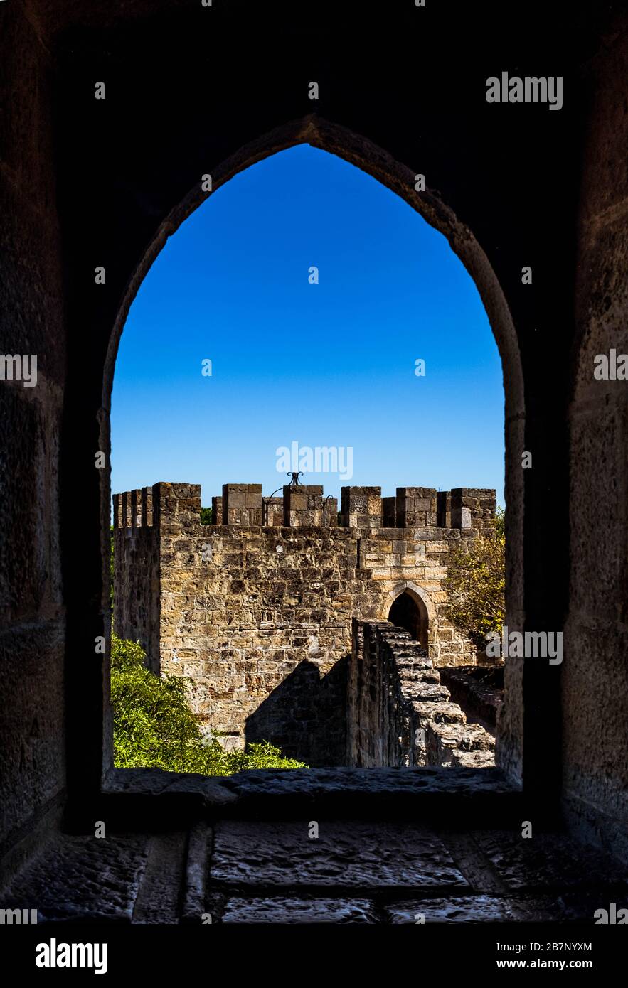 A view of Cistern tower from arched window of São Jorge Castle Stock ...