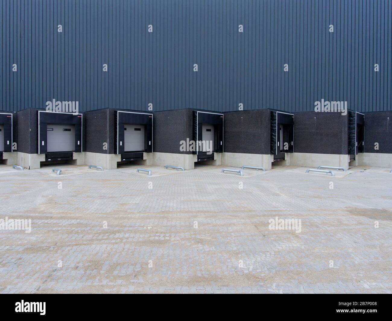 Outdoor view of loading docks of a warehouse with gray facade Stock ...