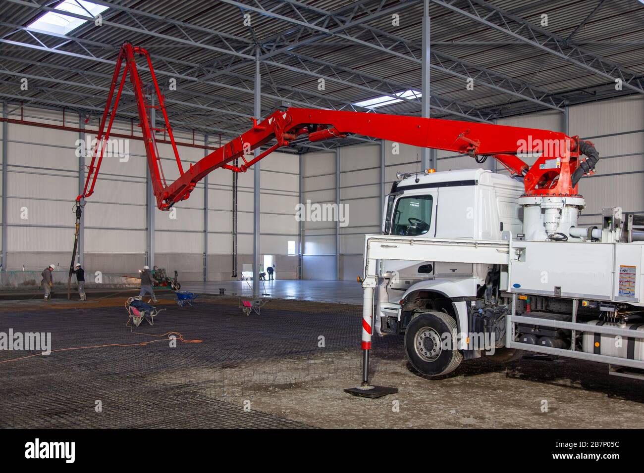 White pumpcrete pouring concrete for the flooring of a new warehouse ...