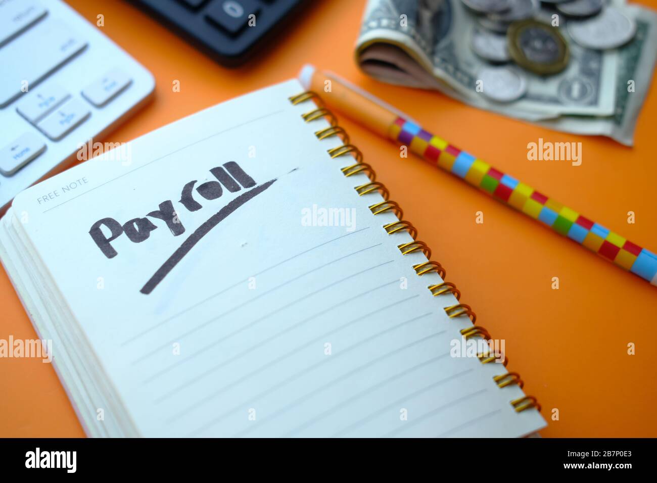 payroll word on notepad with calculator on color background Stock Photo ...