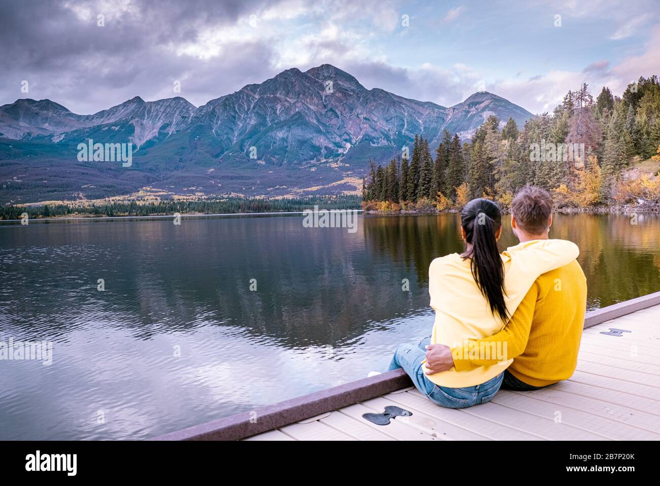 couple by the lake watching sunset, Pyramid lake Jasper during autumn ...