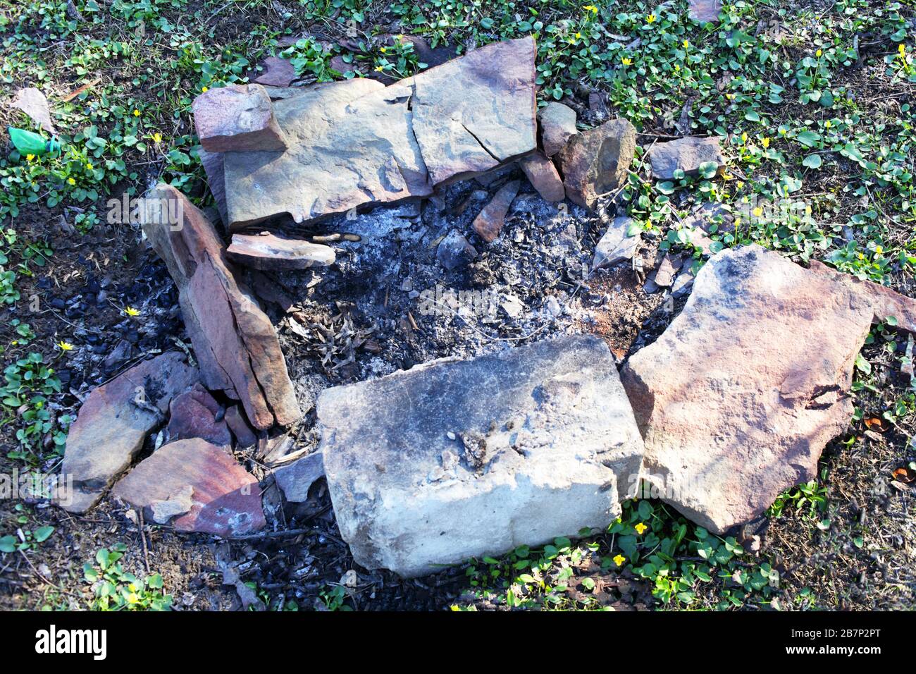 Campfire place in nature fenced with wild stone Stock Photo - Alamy