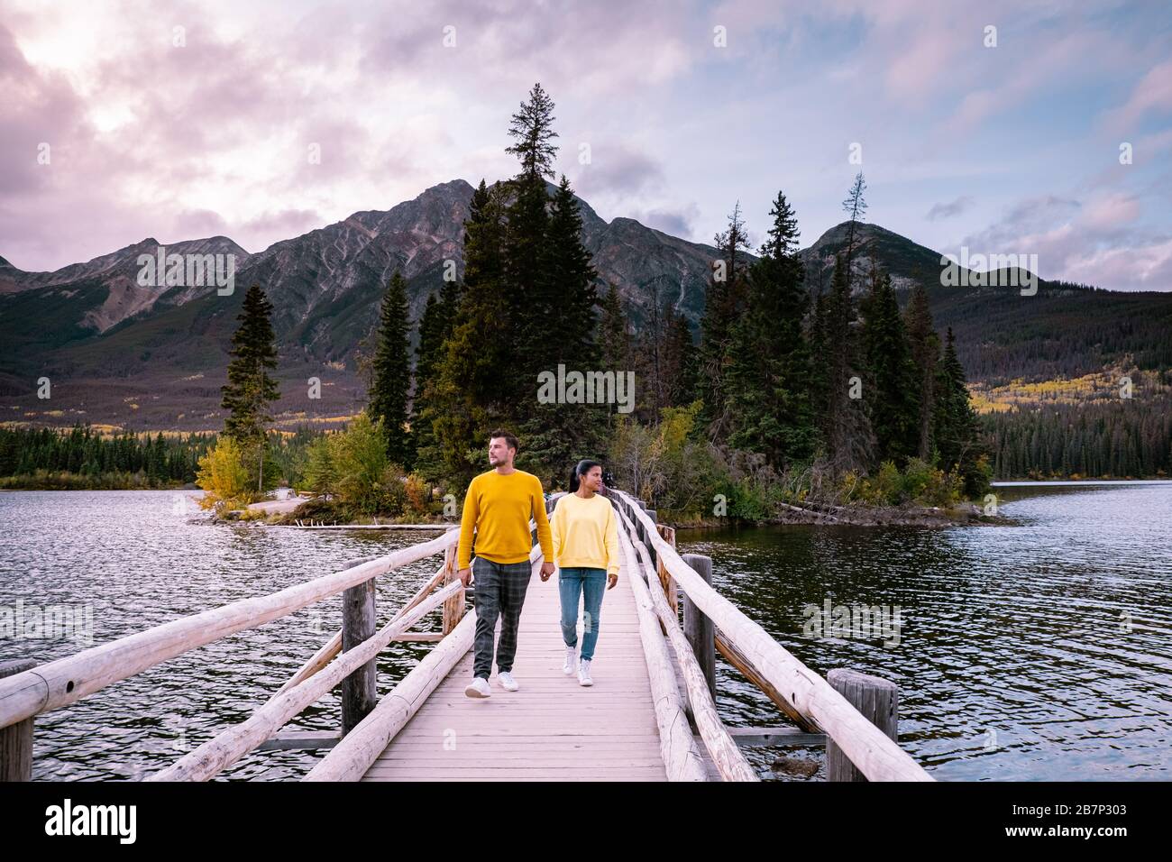 couple by the lake watching sunset, Pyramid lake Jasper during autumn ...