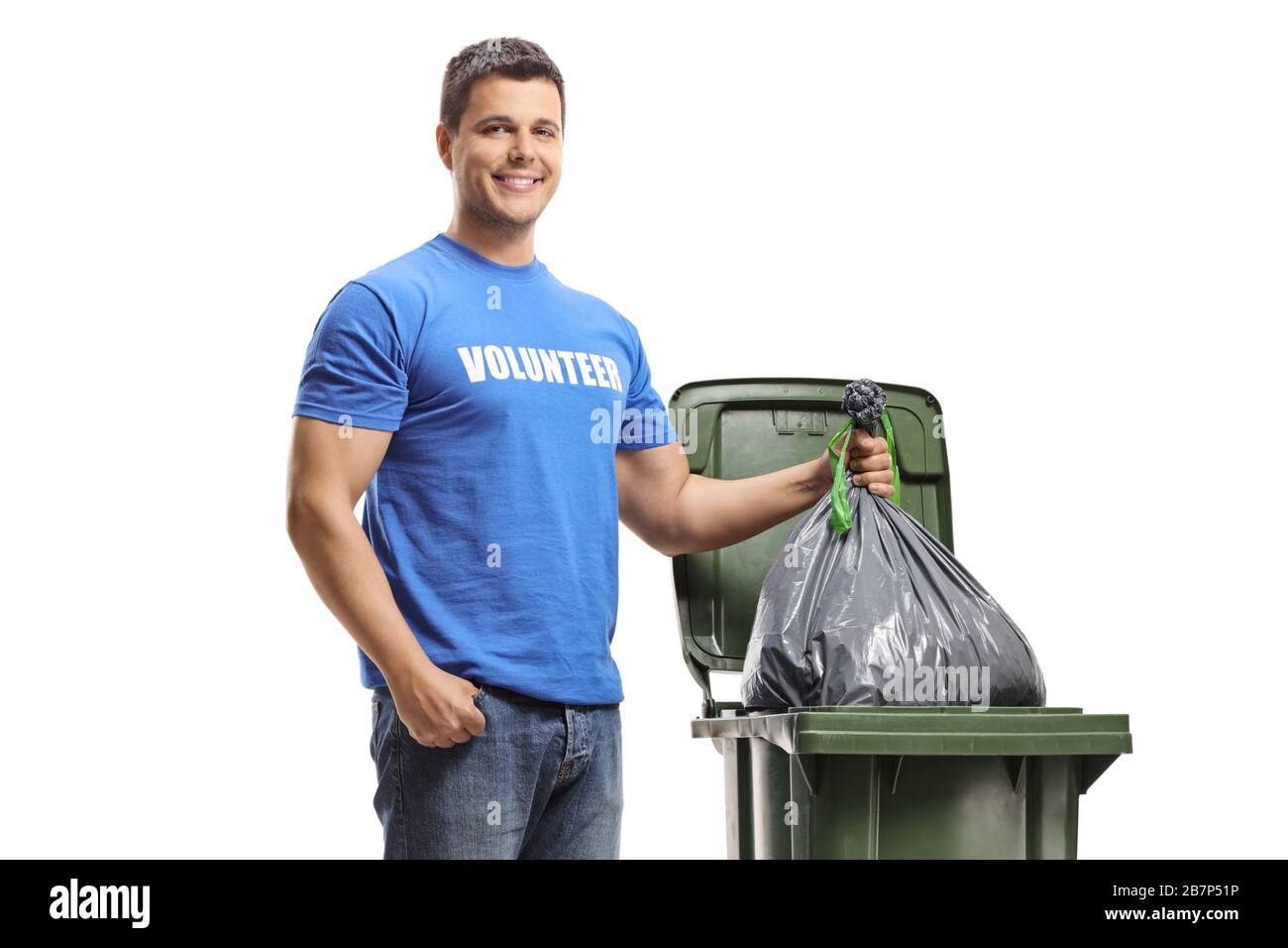 Young man volunteer throwing a plastic bag in a bin isolated on white ...