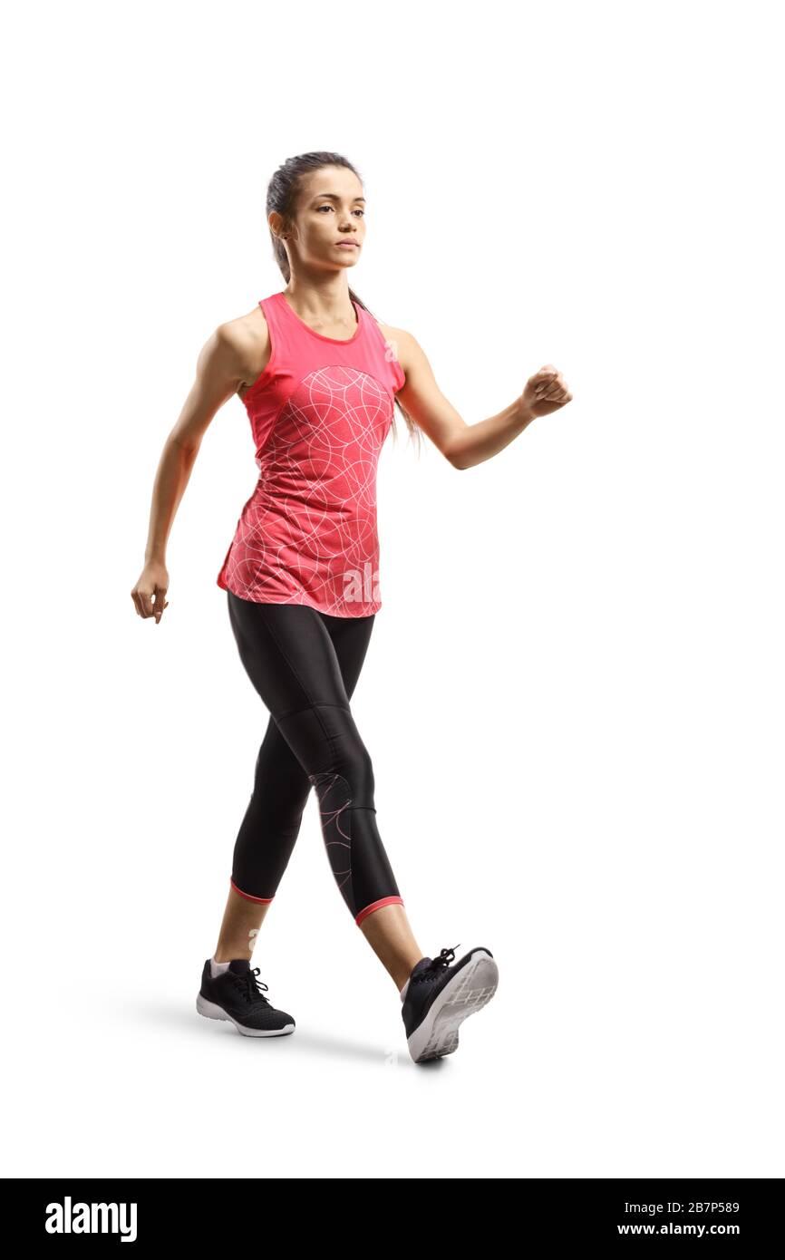 Full length shot of a serious young woman in sportswear walking fast ...
