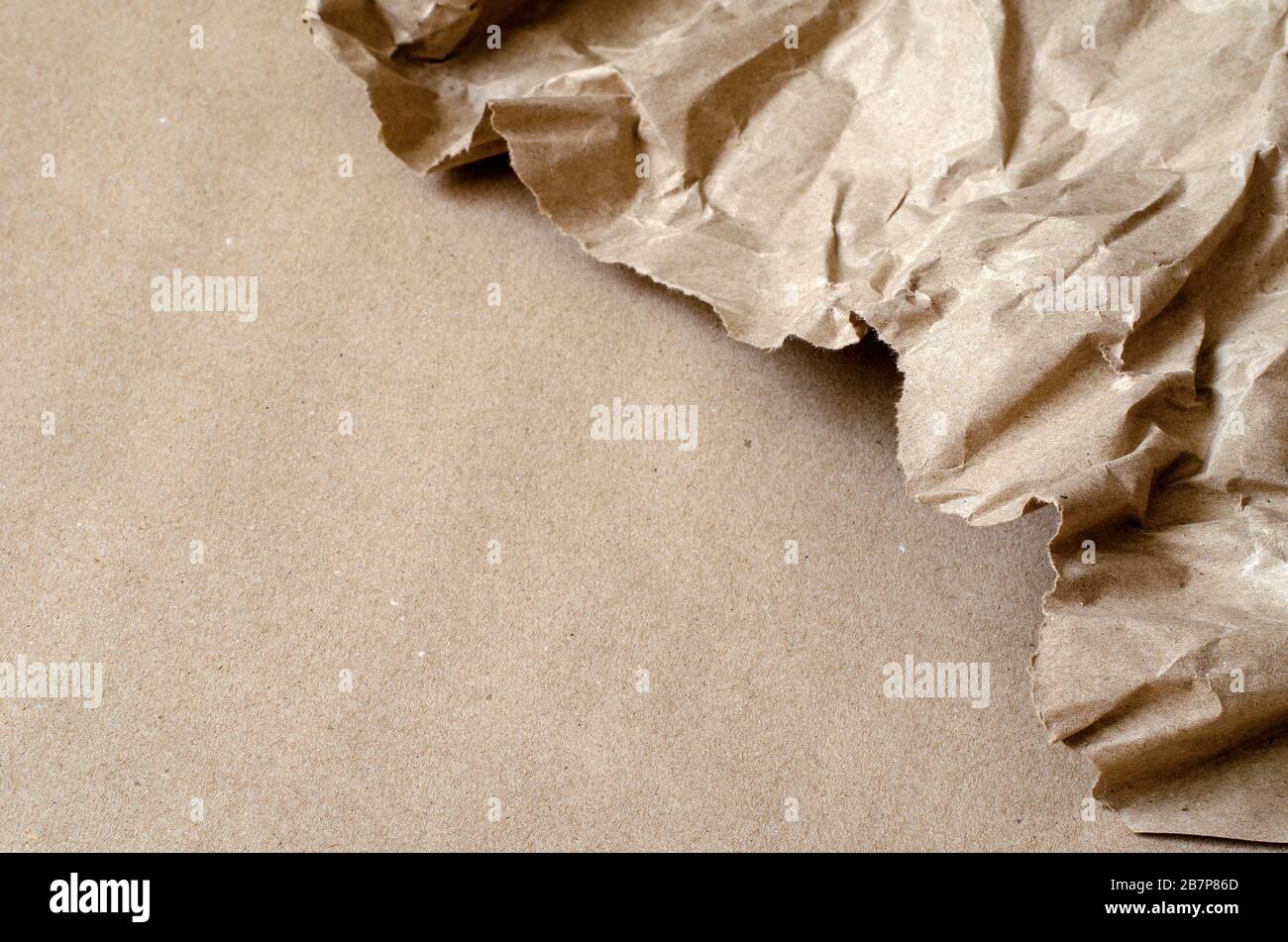 Brown paper background. Crumpled piece of paper with a torn edge. Eye ...