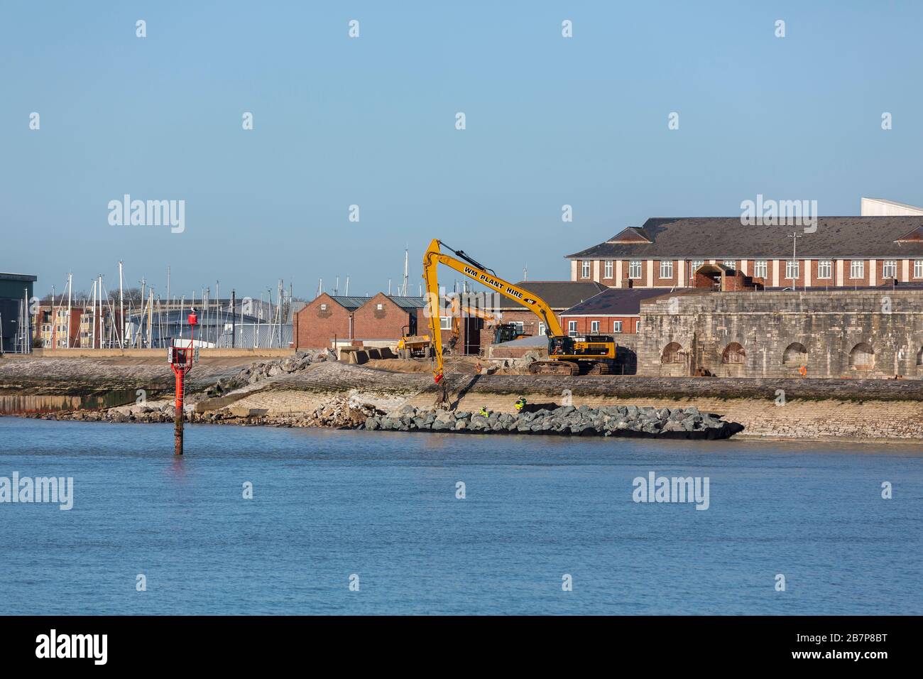Work crew repairing the sea wall at fort blockhouse in gosport Stock ...