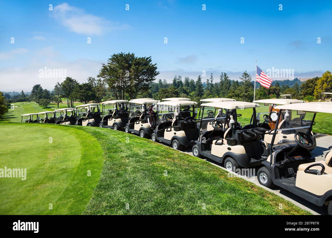 Golf course with carts and blue sky Stock Photo - Alamy