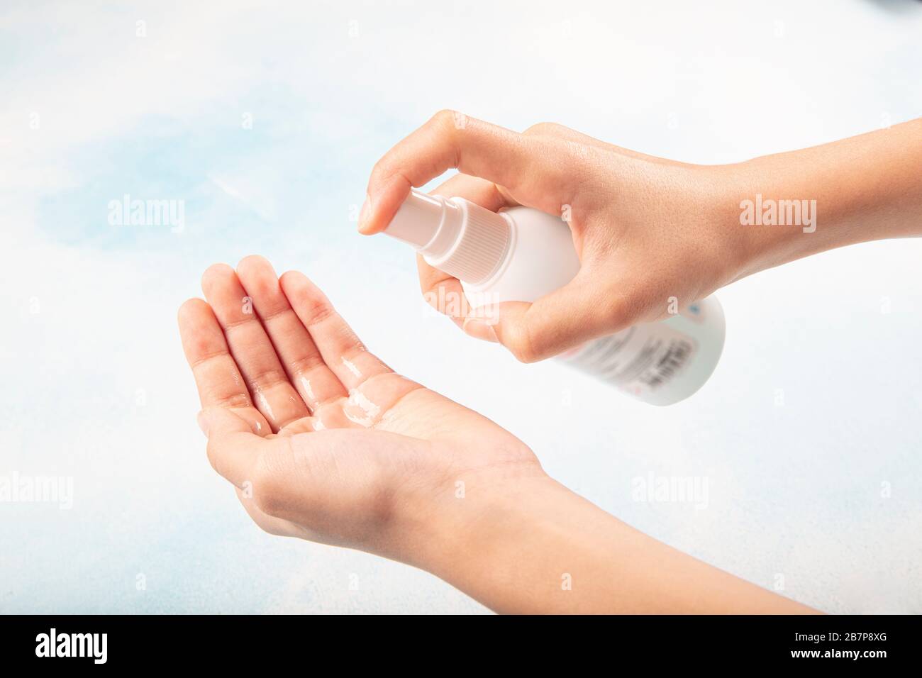 person pouring cologne on their hands for personal hand cleaning Stock ...